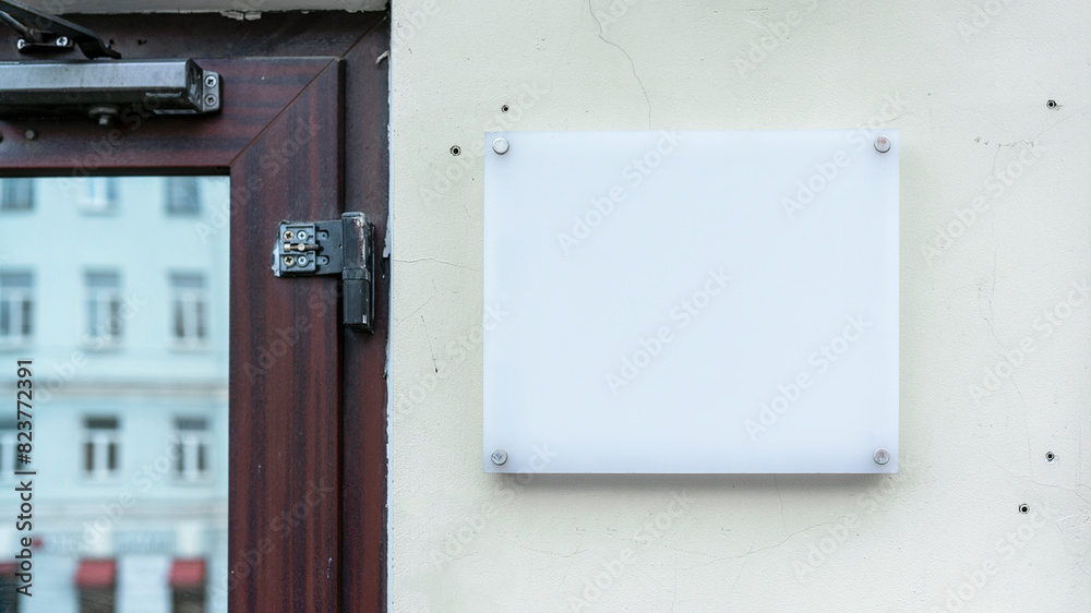 Blank white signboard on wall with screws, mockup for logo or text ...