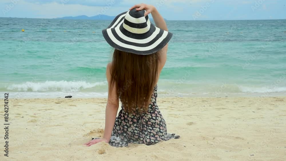 Back side women sitting summer beach wear summer dress and straw hat ...