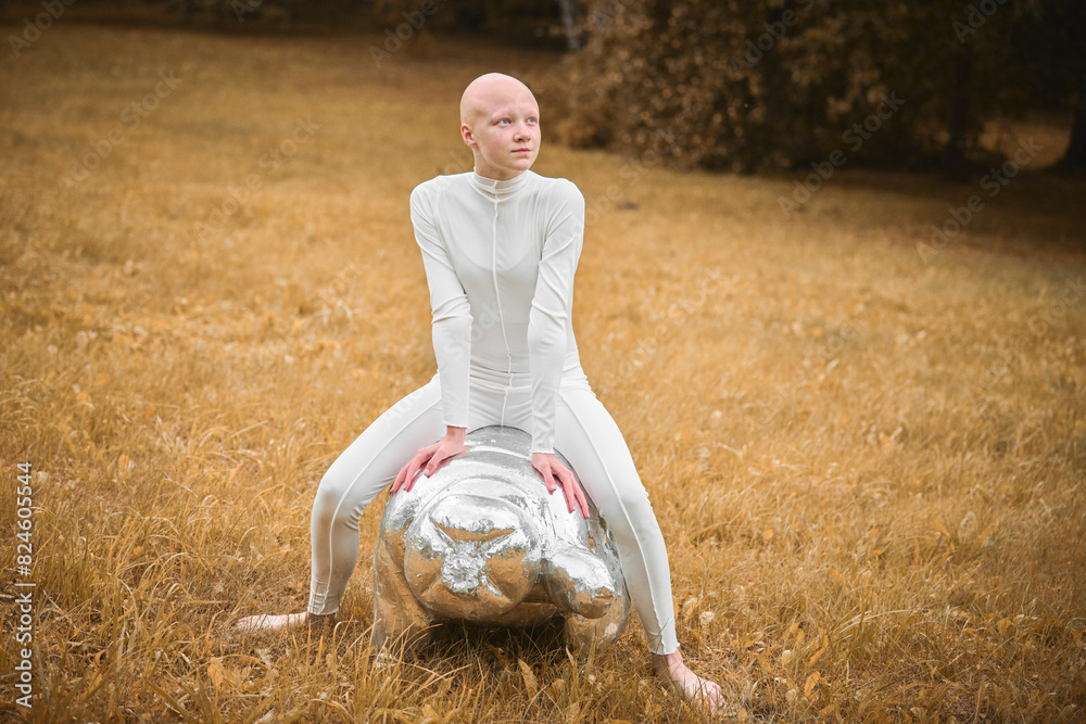 Young hairless girl with alopecia in white cloth sits on tardigrade ...