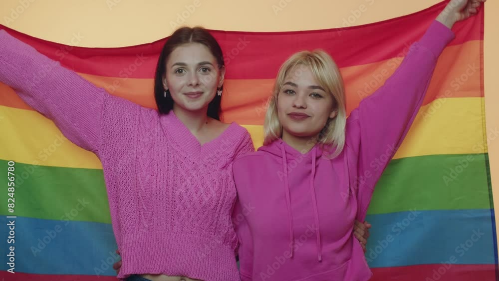Couple Young Lesbians Girls Hugging Happily And Wrapped With Rainbow