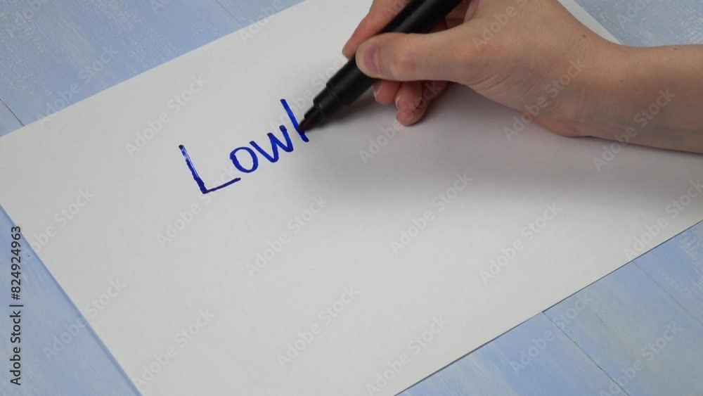 Young girl writes on a sheet of paper various words and expressions of ...