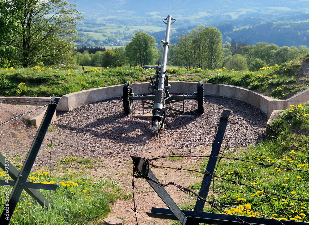 gun position behind wire barriers in trench. anti-tank measures made of ...