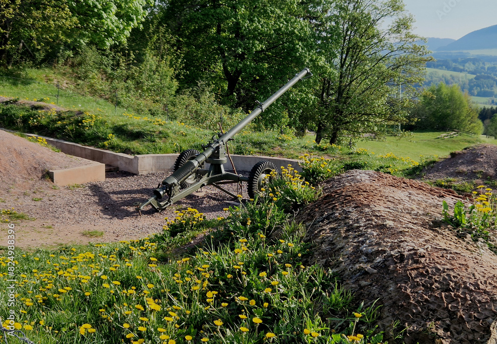 gun position behind wire barriers in trench. anti-tank measures made of ...