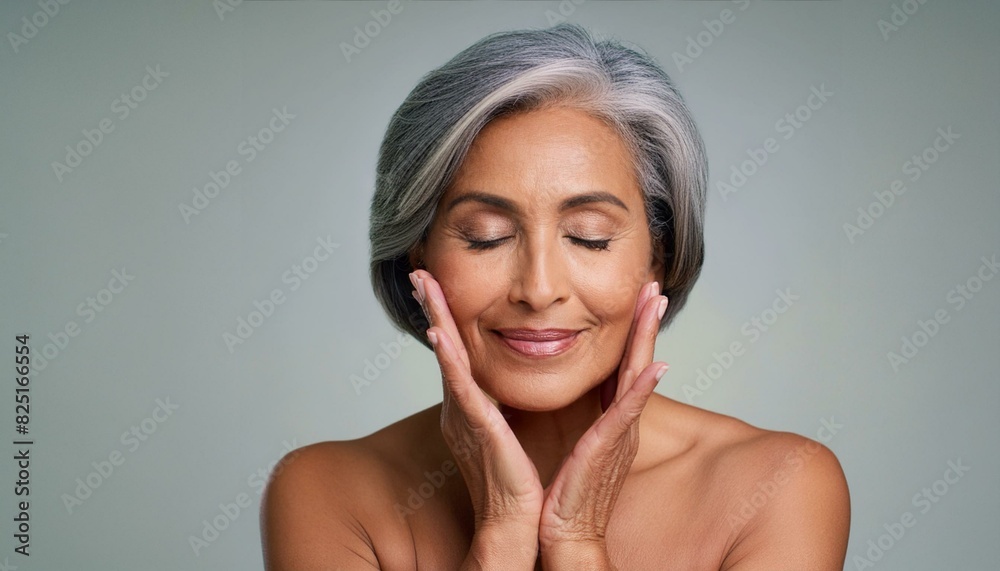 gorgeous senior older woman with closed eyes touching her perfect face ...