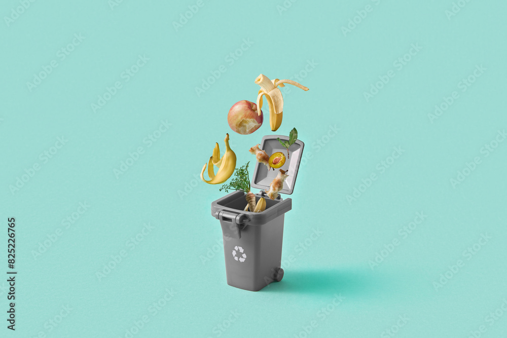 Mix of expired food waste floating above fray garbage bin Stock Photo ...