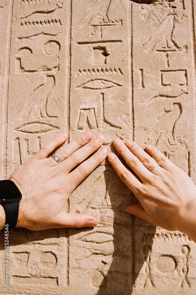 Hands of a married couple over ancient Egyptian hieroglyphs Stock Photo ...