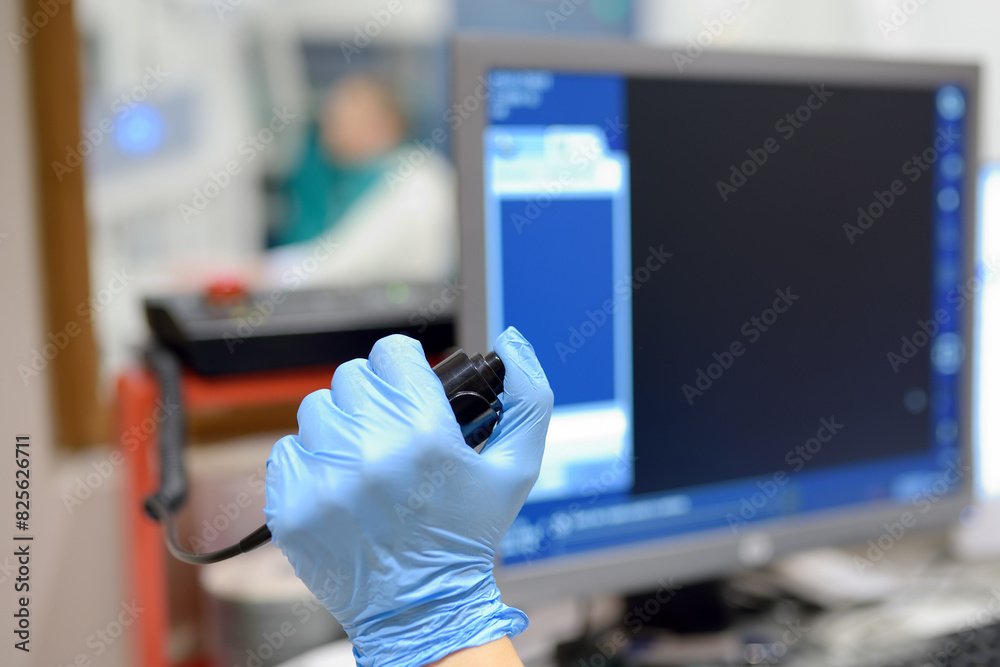 Radiologist is going to take X ray of patient in X-ray room of modern clinic. Close up photo of ...