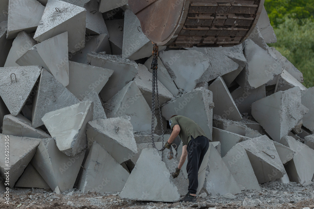Loading and transporting dragon teeth for defense. Concrete pyramids ...