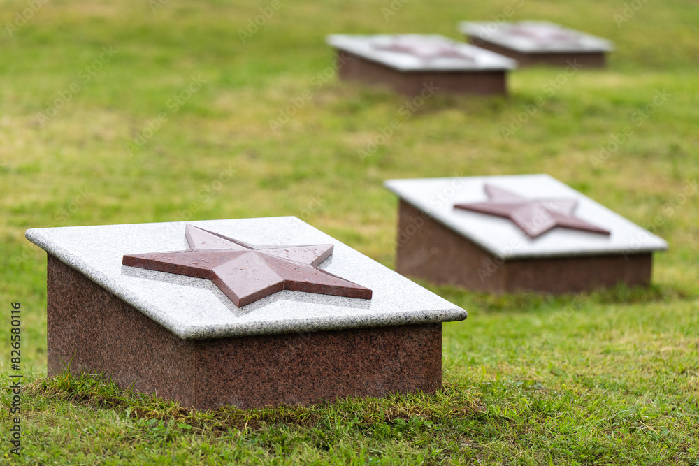 Mass grave. Tombstones with a star. Tombstones of soldier mass graves ...