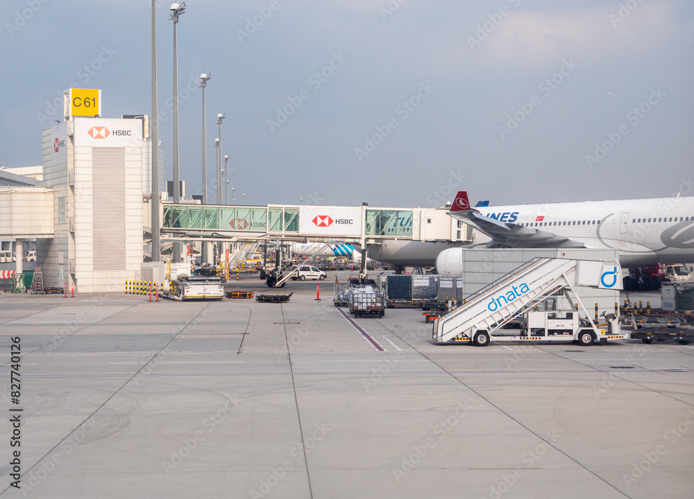 Dubai, UAE - May 14, 2024: Various planes at gate with boarding bridge ...