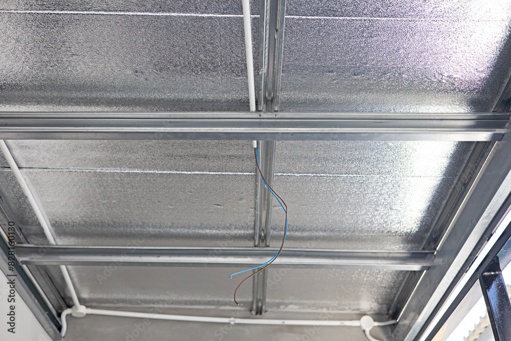 Plastic electrical conduit installed on metal sheet roof ceiling Stock ...