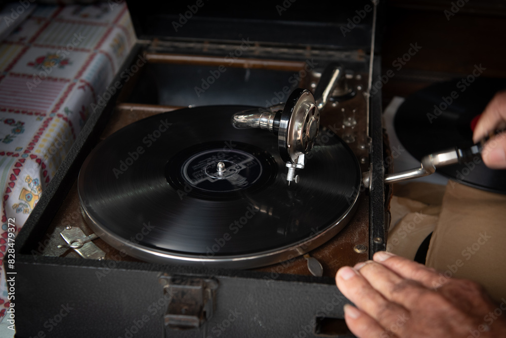 Old vintage turntable vinyl record player with disc spinning and ...