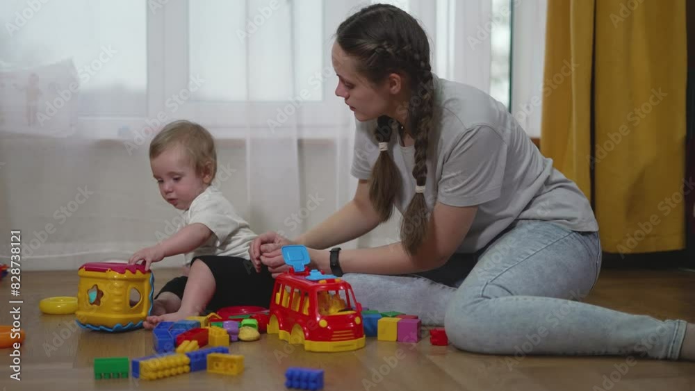 Engaged play with mom blocks. floor play child learns with mom. Mother ...