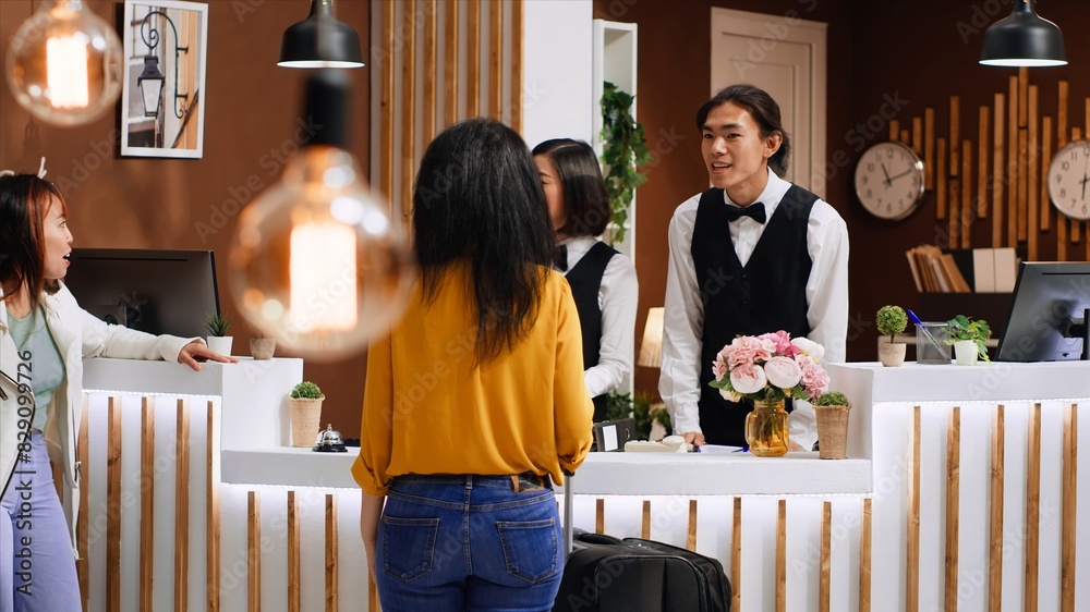 Hotel guests using service bell for assistance at front desk, calling ...