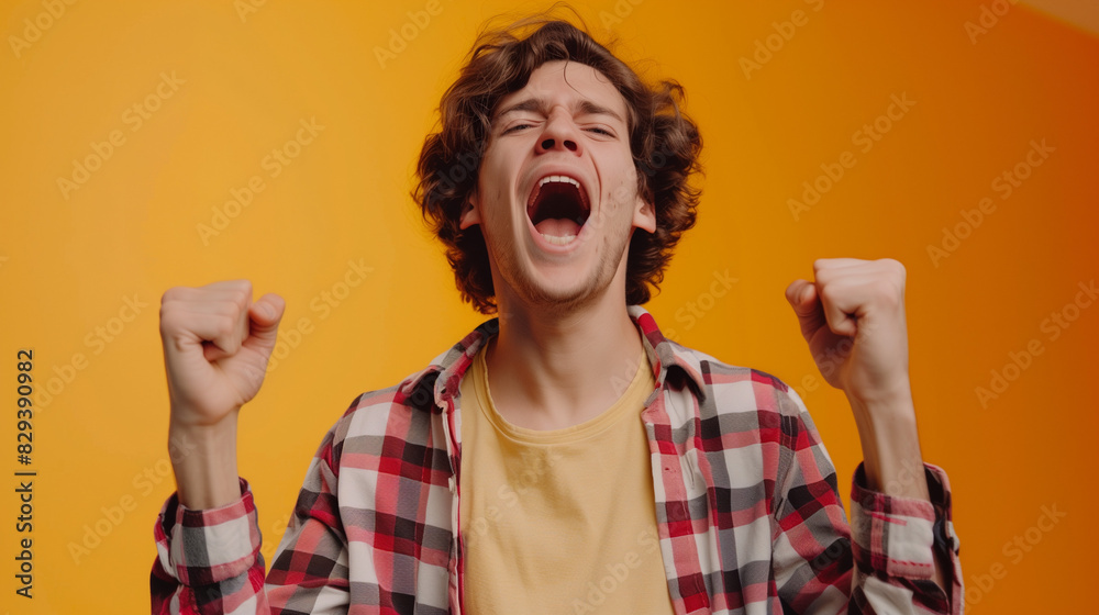 In everyday clothes, with a smile on his face, a young man lets out an ...