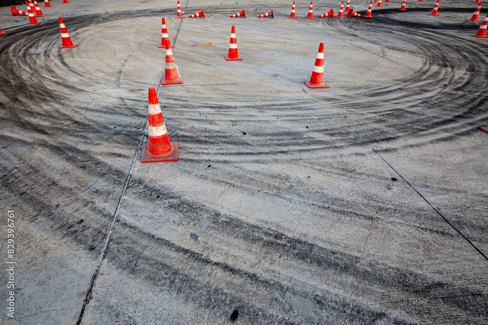 Race track road with tire mark skid road Backgroundn and traffic cone ...