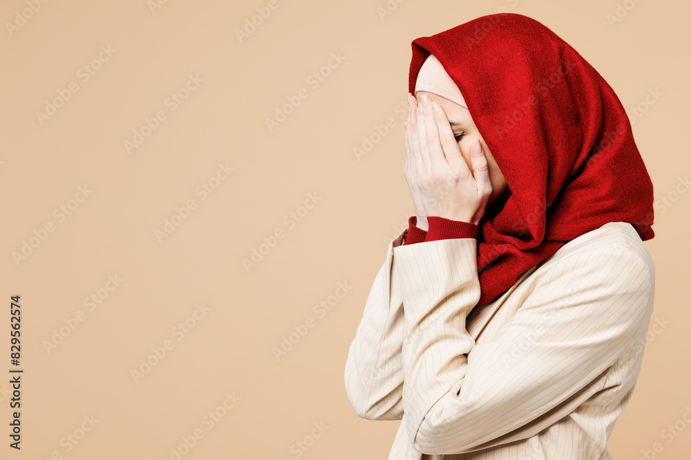 Side view young sad upset Arabian Asian Muslim woman she wearing red ...