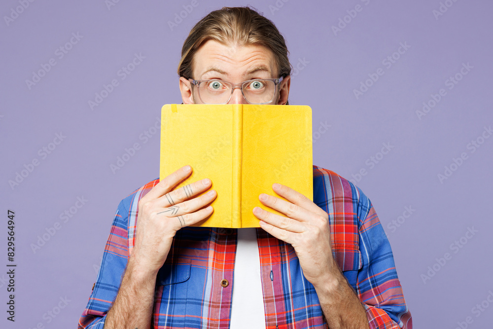 Young shocked surprised smart boy student wear blue casual clothes hold ...