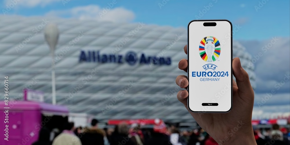Euro 2024 app on a screen, against the backdrop of a Allianz Arena ...