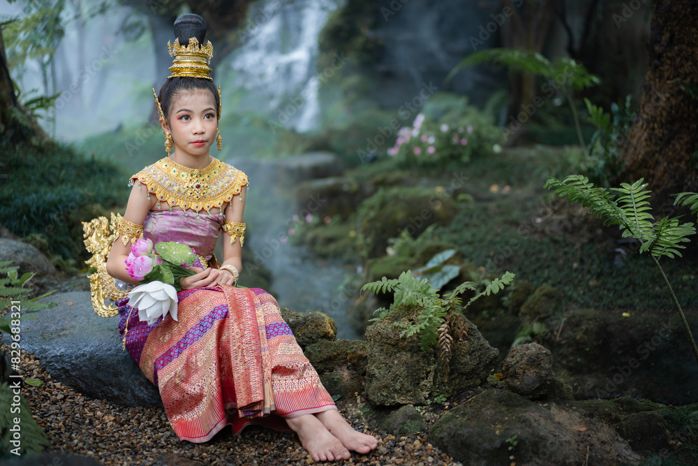Beautiful girl in a Kinnari dress in green natural with the moss and ...