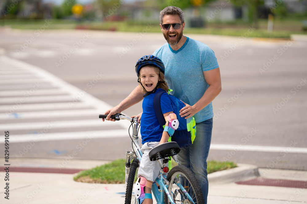 Father teaching son riding bike. Dad helping child son to ride a ...