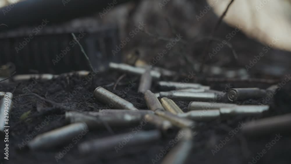 Cinematic slow motion footage spent bullet casings falling on the ...