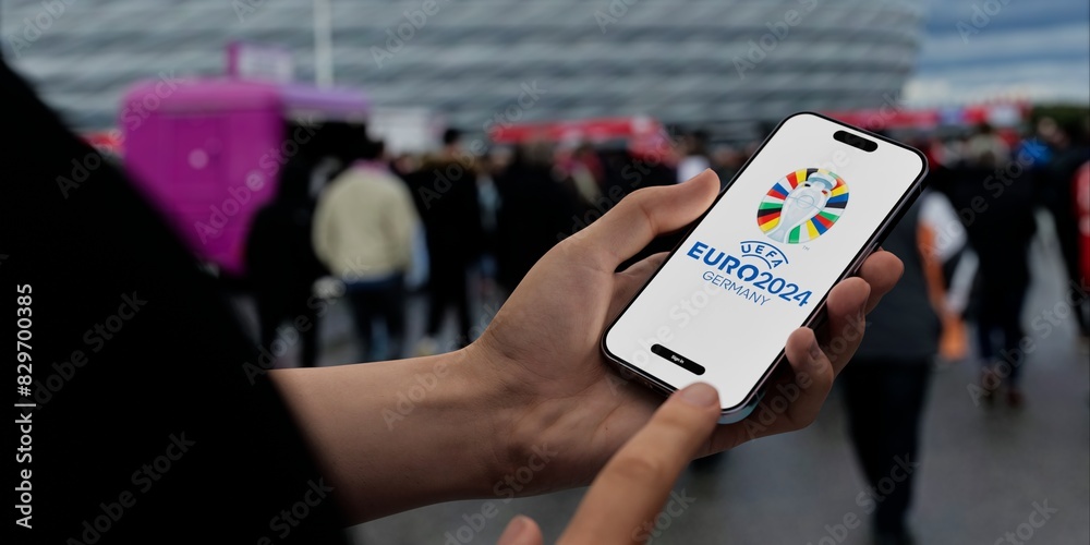 Euro 2024 app on a screen, against the backdrop of a Allianz Arena ...