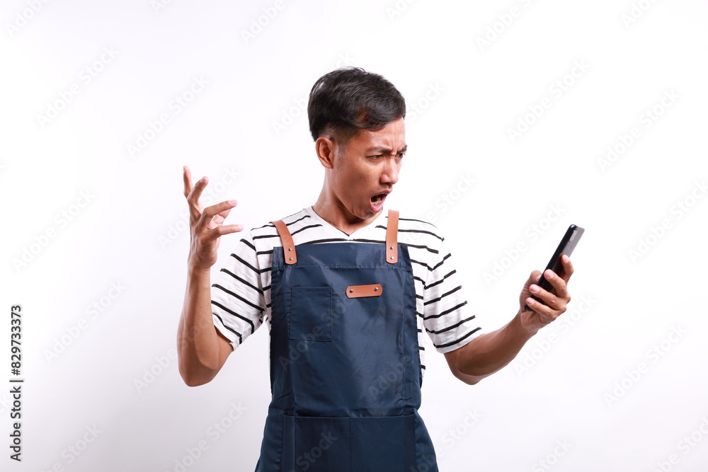Young angry asian man barista bartender barman employee wear blue apron ...