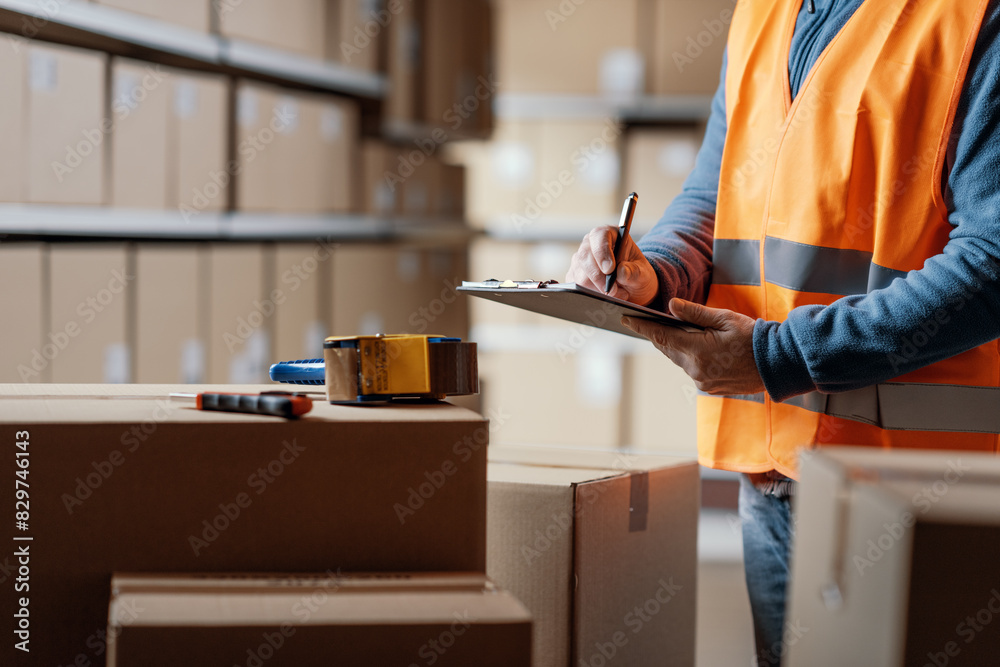 Warehouse operative checking a purchase order Stock Photo | Adobe Stock