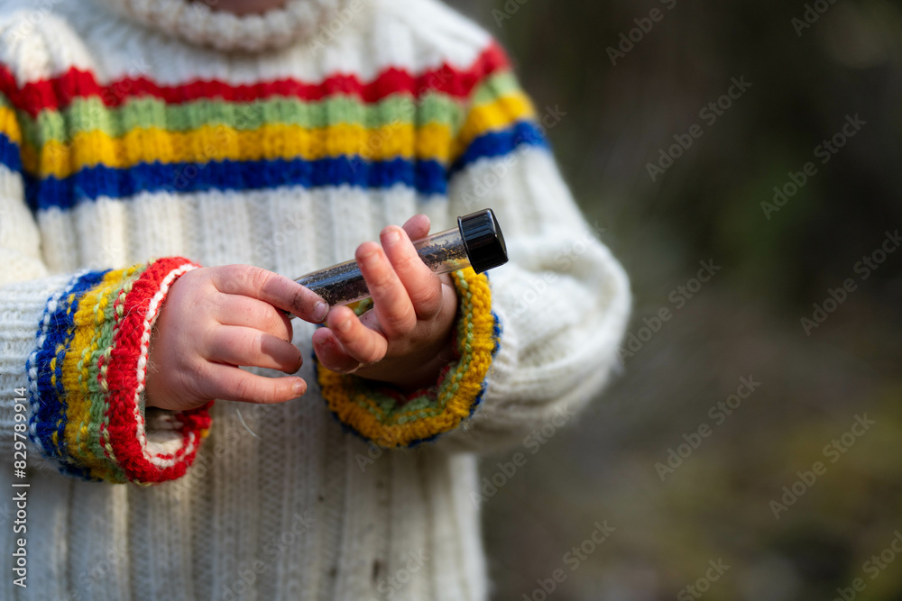 child taking a soil sample for a soil test in a field. family farm ...