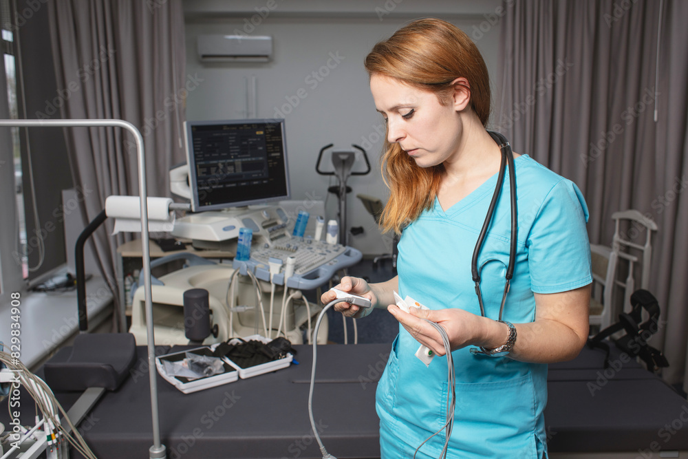 Doctor showing ECG holter monitor to patient in pediatric clinic ...