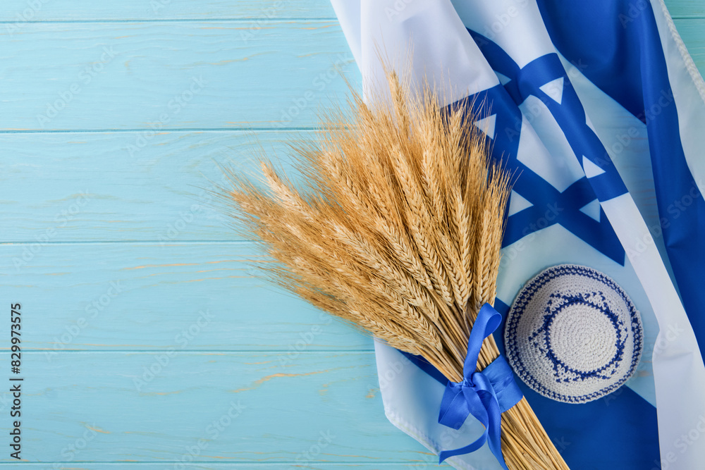 Shavuot jewish background. Ripe bouquet of wheat with blue ribbon with ...