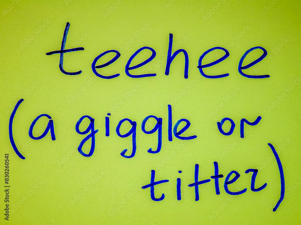 Word "teehee", written on a sheet of green paper, various words and ...