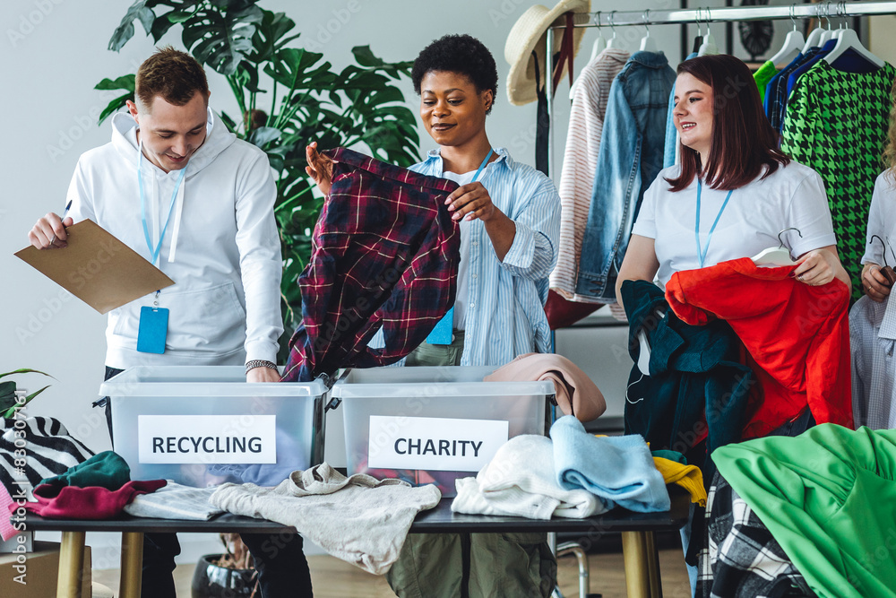 Process of sorting textile for donation, charity, recycling. Young ...
