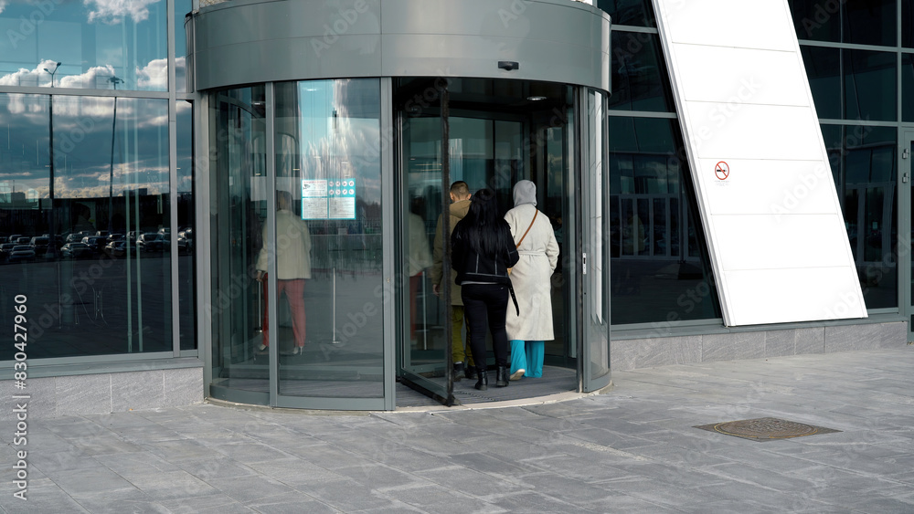 A revolving door in modern building, shopping center. Media. Glass ...