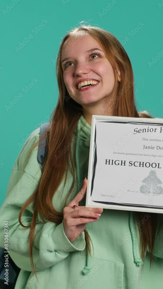Vertical video Portrait of smiling student holding high school diploma ...