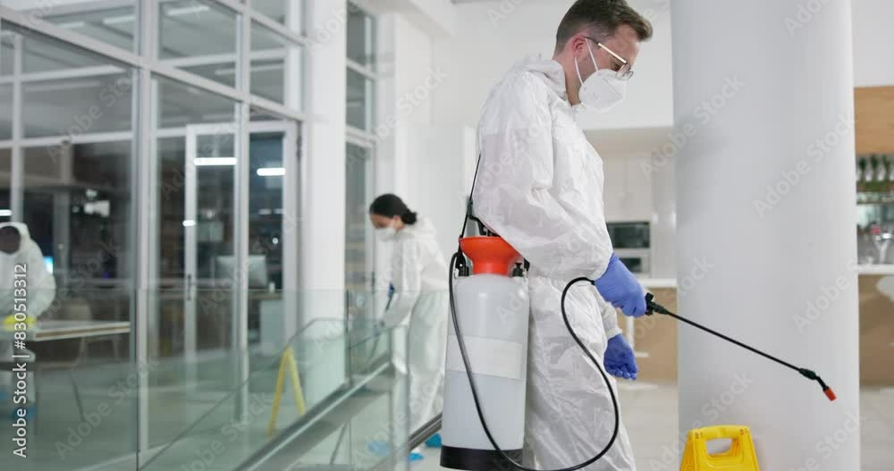 Man, biohazard suit and spray for cleaning in office, pandemic and ...