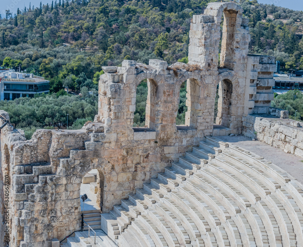 Stone steps of an ancient theatre surrounded by greenery and historical ...