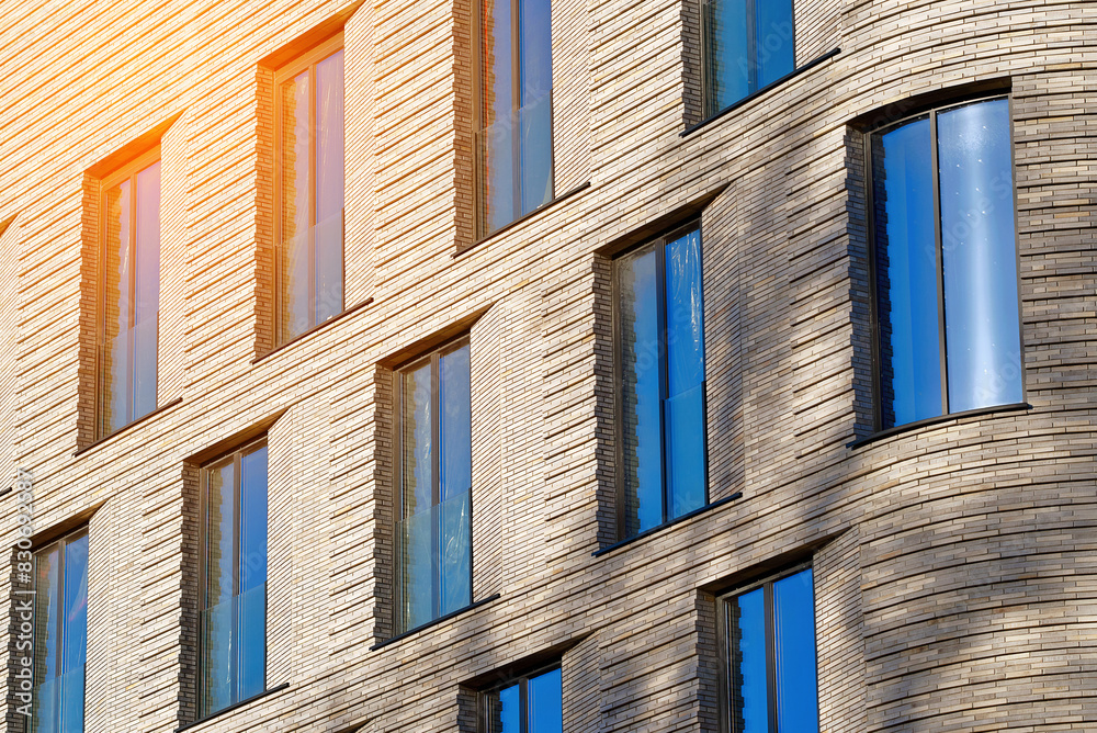 Clinker brick wall facade of residential building with multiple windows ...