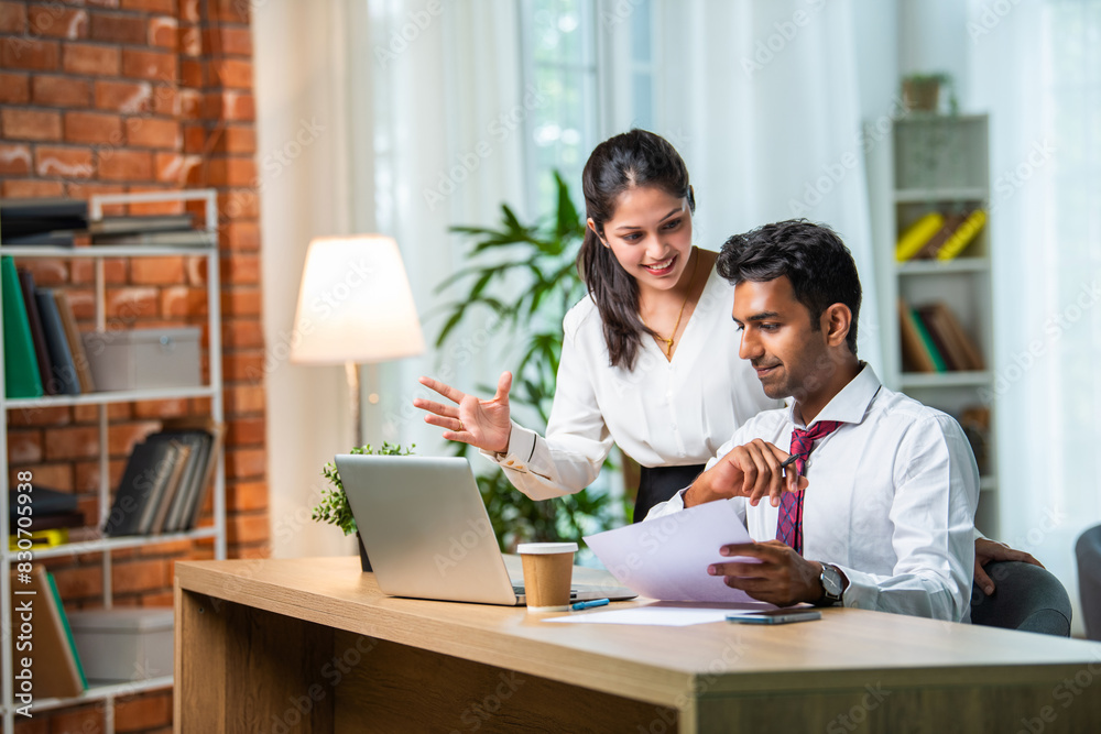 Indian asian young CEO businessman working with female colleague in the ...