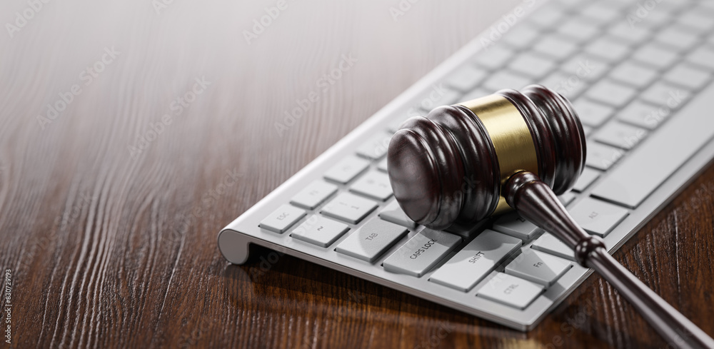 Gavel at the computer keyboard: Legal and law concept. Wooden hammer of ...