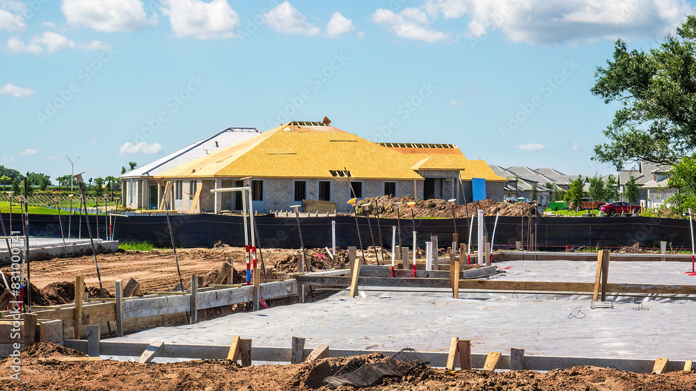 Concrete foundation with utility connections (white conduits) and ...