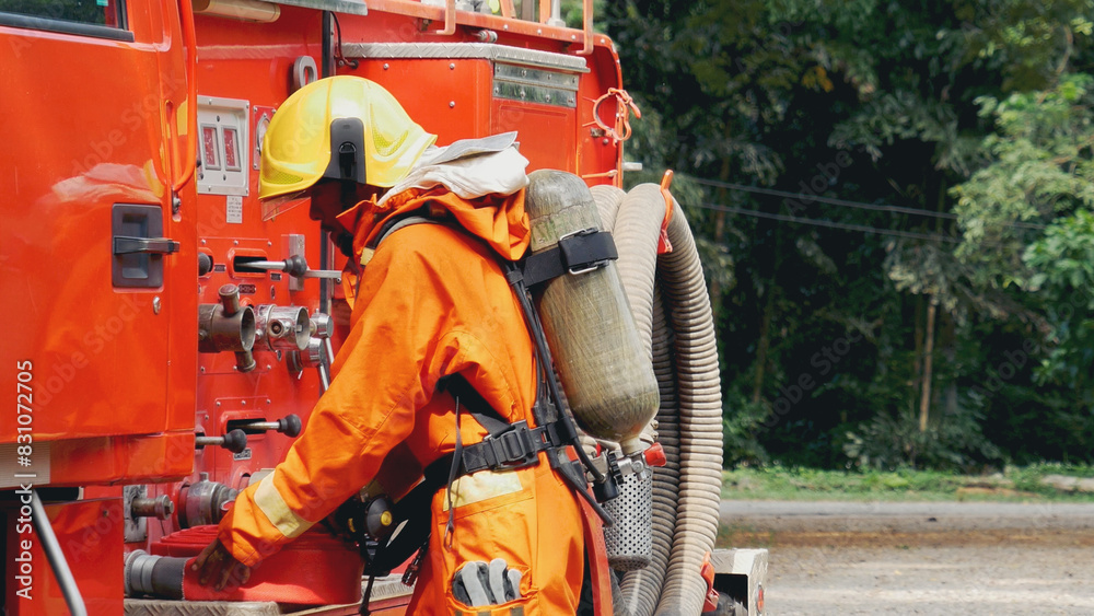 Fireman prepare equipment fighting extinguisher at fire engine truck ...