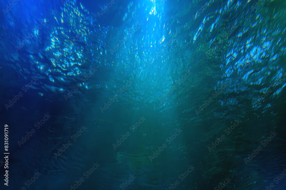 A shot taken from beneath the surface of the sea looking up at the sky ...