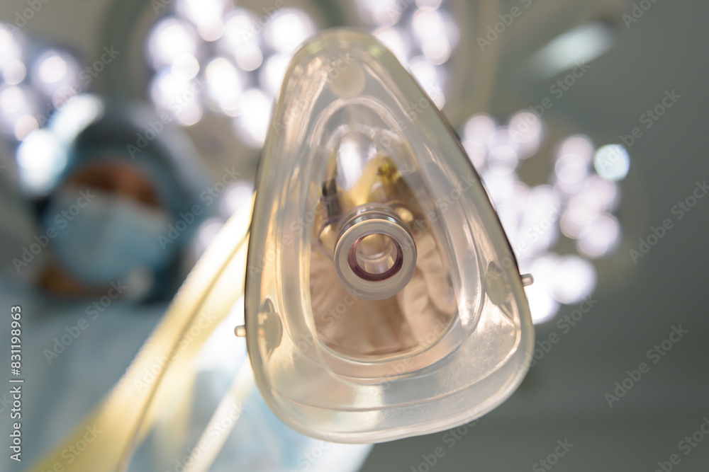 Anesthesiologist puts an oxygen mask on the patient. Preparing for ...