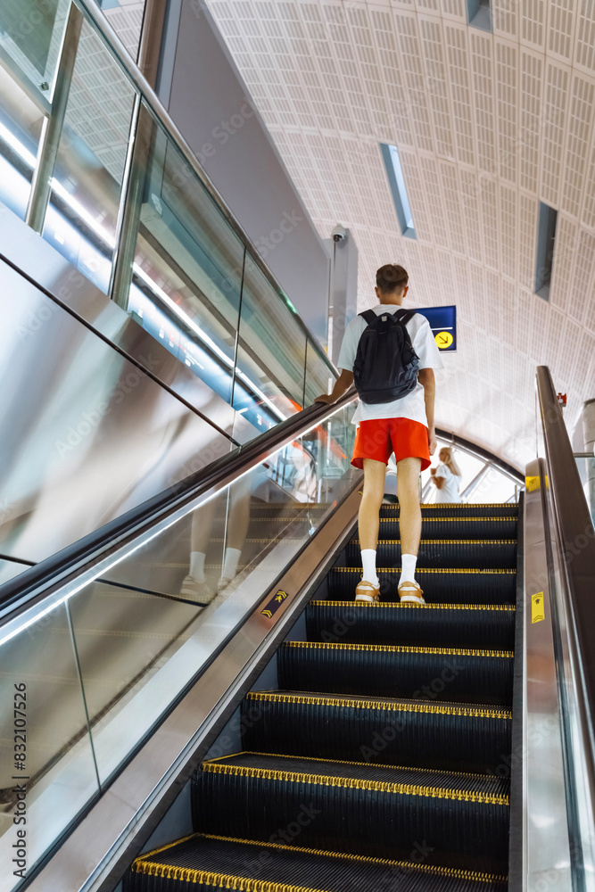 People climb escalator at metro station Dubai. Dubai metro. Escalator ...