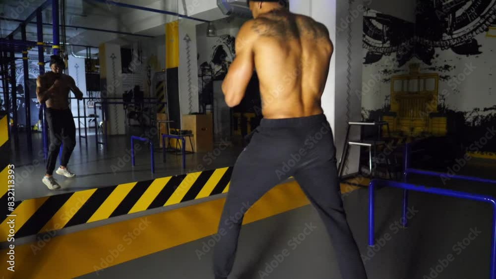 Young afro american sportsman practicing shadow boxing at modern gym ...