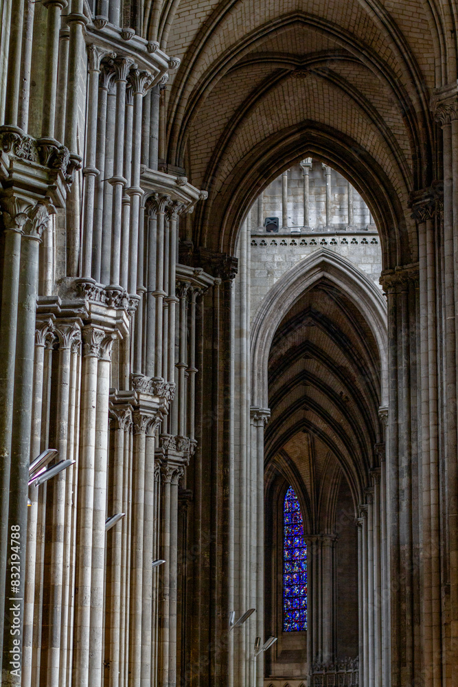 The image shows the interior of a Gothic cathedral with tall arched ...