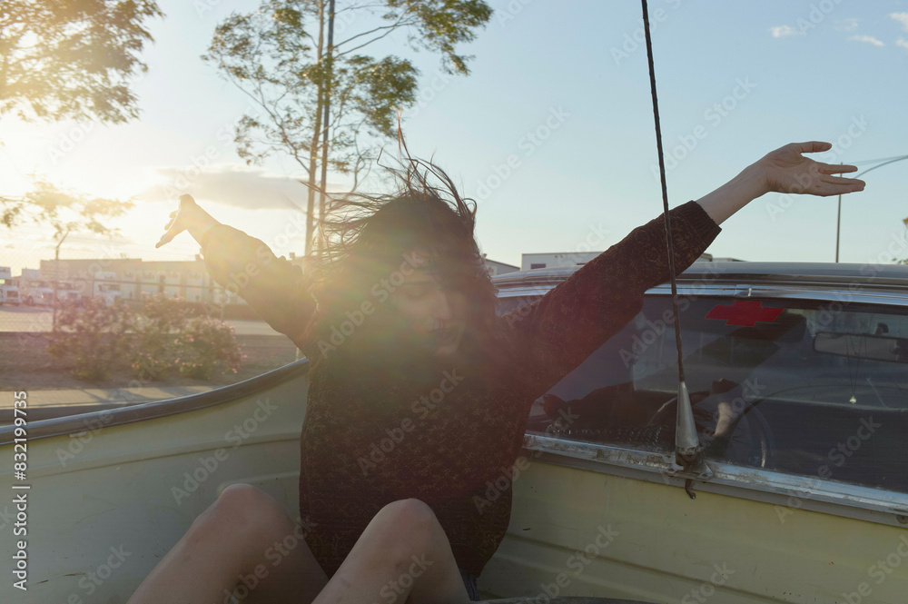 A joyful person spreads their arms wide, embracing the wind with their ...