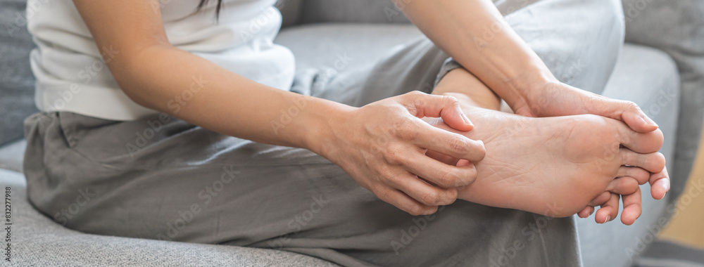 Foot pain, ache asian young woman hand scratch feet, itch foot, problem ...